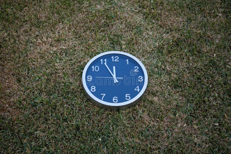 Wall clock in the grass stock image. Image of hour, business - 10898997
