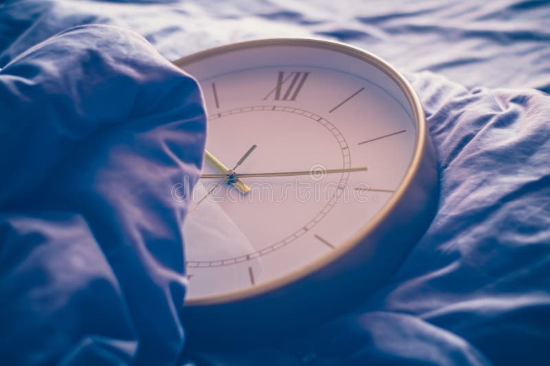 Clock in bed stock photo. Image of reminder, rest, alarm - 187169658