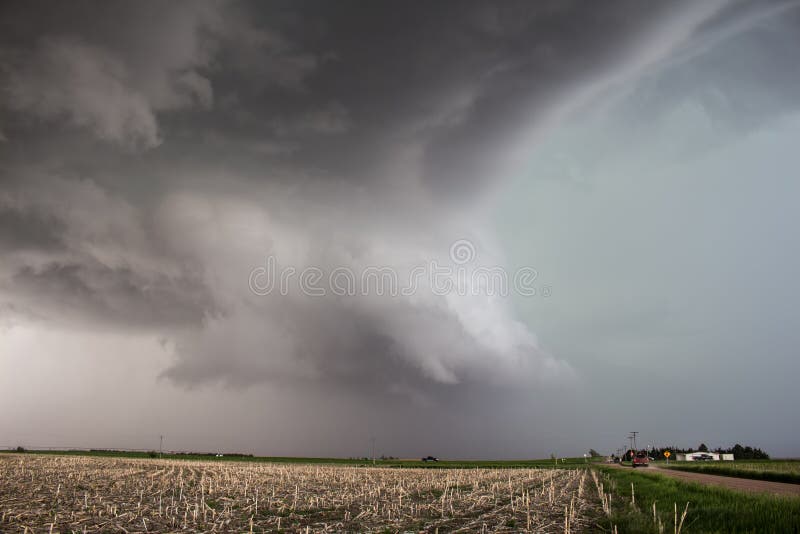 A Wall Cloud Gathers Under the Base of a Supercell Storm Over a Field ...