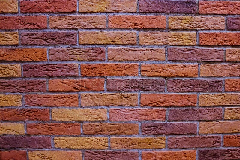 Brick Wall With Red, Orange And Yellow Colored Bricks Stock Photo ...