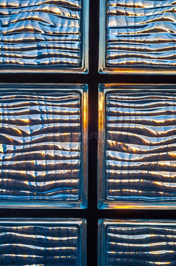 A Shimmering Glass Brick Wall with Wavy Patterns Creates a Modern ...