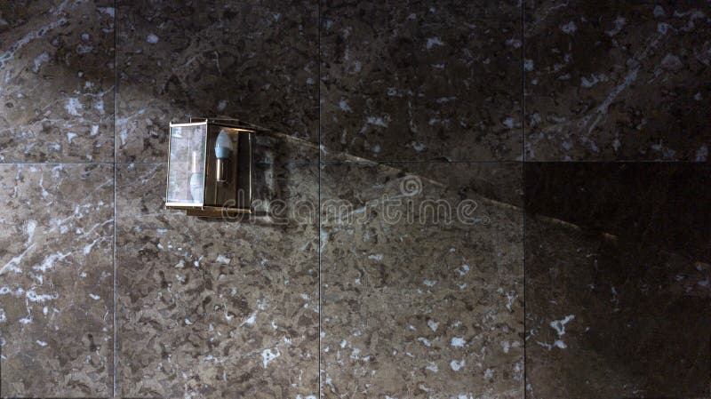 Wall Covered with Marble Tiles with a Muted Wall Light Stock Photo ...