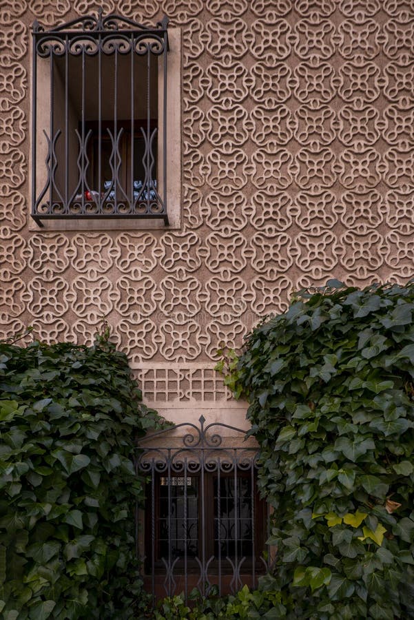 A Wall Decorated with Bas-reliefs, Windows with Bars and Bushy Vines ...