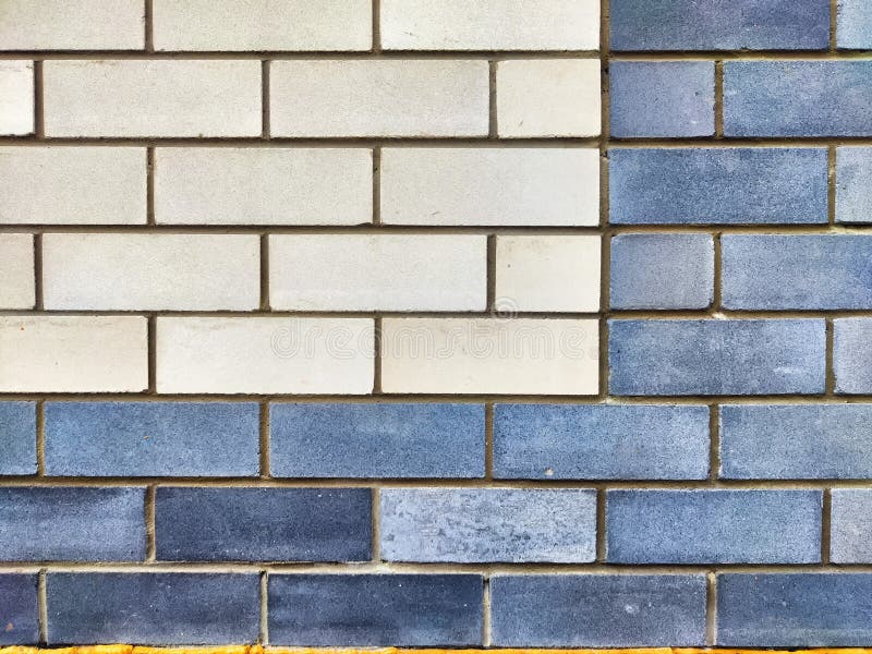 A Wall Displays a Striking Pattern of Alternating Light and Dark Bricks ...