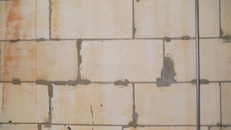 Primed Wall Made of Foam Blocks. Orange Primer Applied To the Wall. a ...