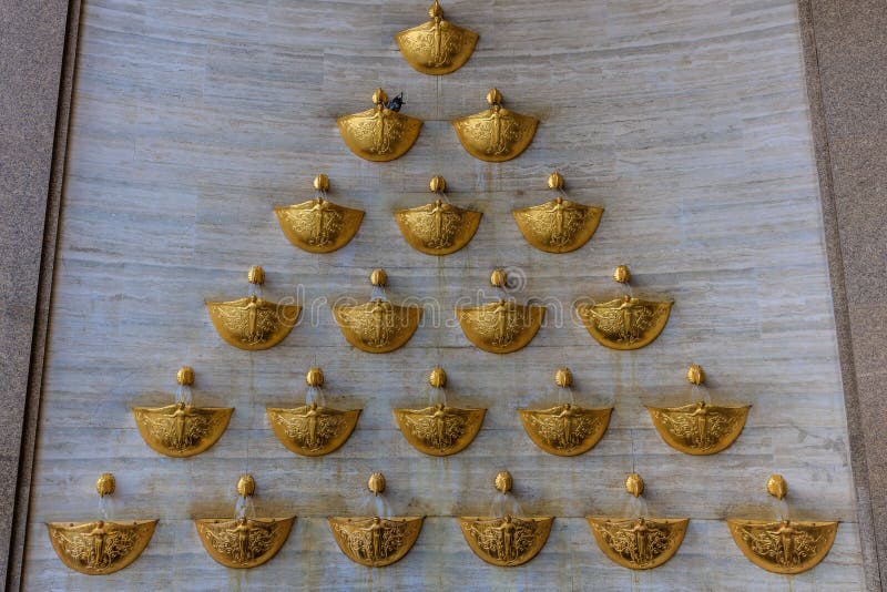 Wall with Golden Water Taps in a Triangle Shape Stock Photo - Image of ...
