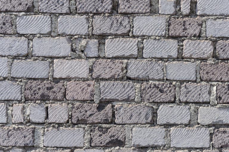 Wall of gray stone blocks stock photo. Image of brick - 102404560