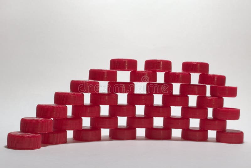 Wall with Holes Pattern. Made of Red Ribbed Plastic Bottle Caps ...