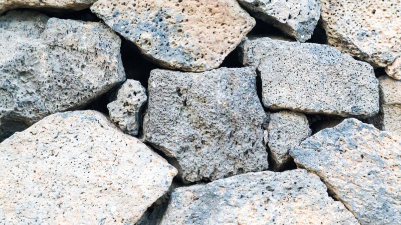 Wall of grey lava rocks stock photo. Image of textured - 150451544
