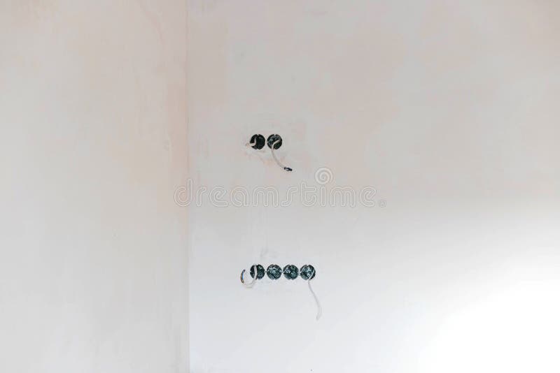 Wall is of Light-colored Plaster and Has Several Outlets. Professional ...
