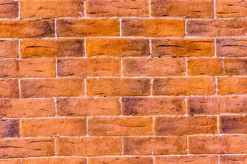 A Wall Made of Decorative Orange Bricks with White Mortar Joints. Stock ...