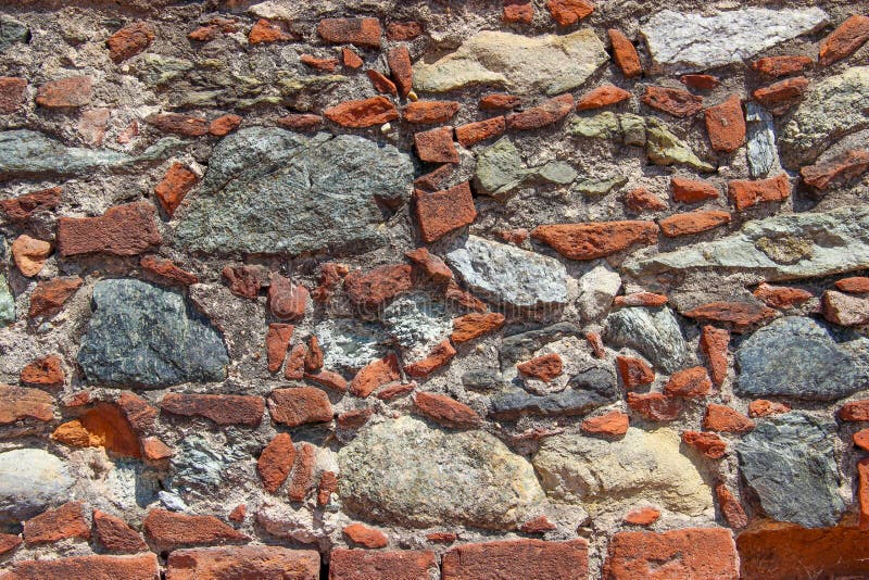 Wall Made of Natural Rocks, Bricks and Scrap Bricks Stock Photo - Image ...
