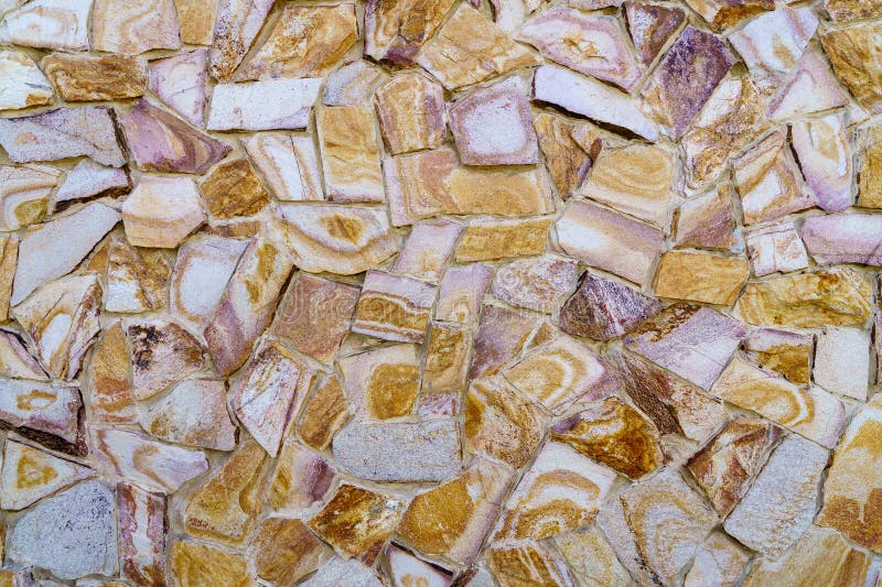 A Wall Made of Stone with a Pattern of Brown and White Stones Stock ...