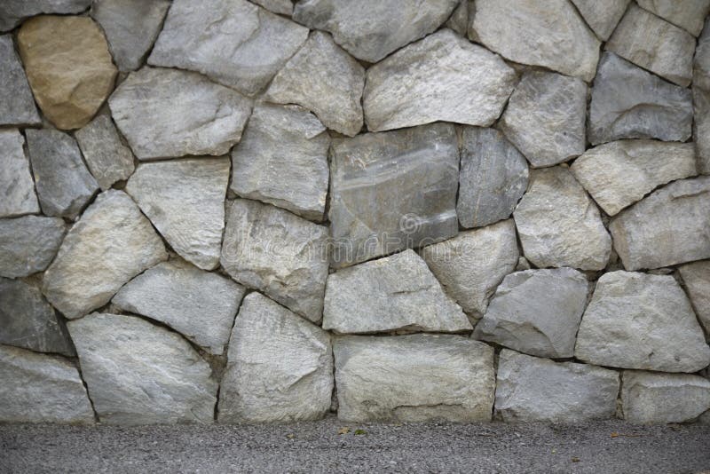 A Wall Made of Stone on the Side of the Road Stock Image - Image of ...