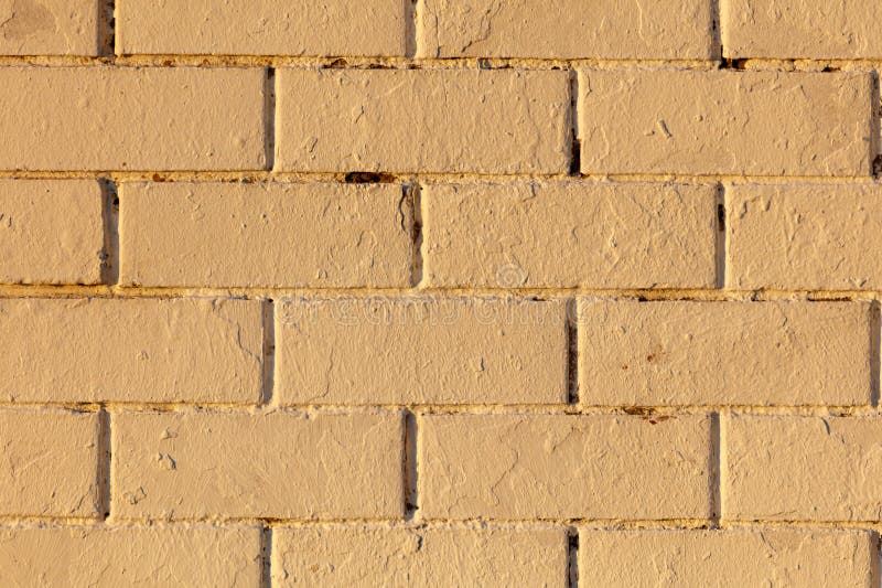 A wall made of tan bricks stock photo. Image of concrete - 345850840