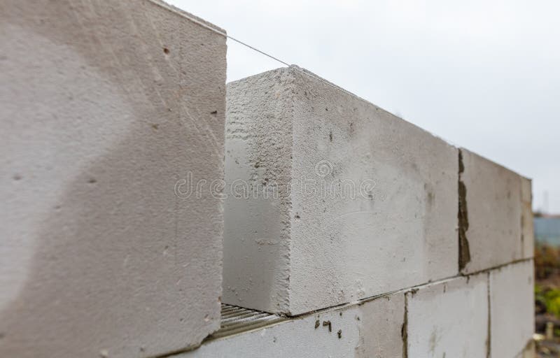 A Wall Made of White Blocks with a Wire Running through it Stock Photo ...