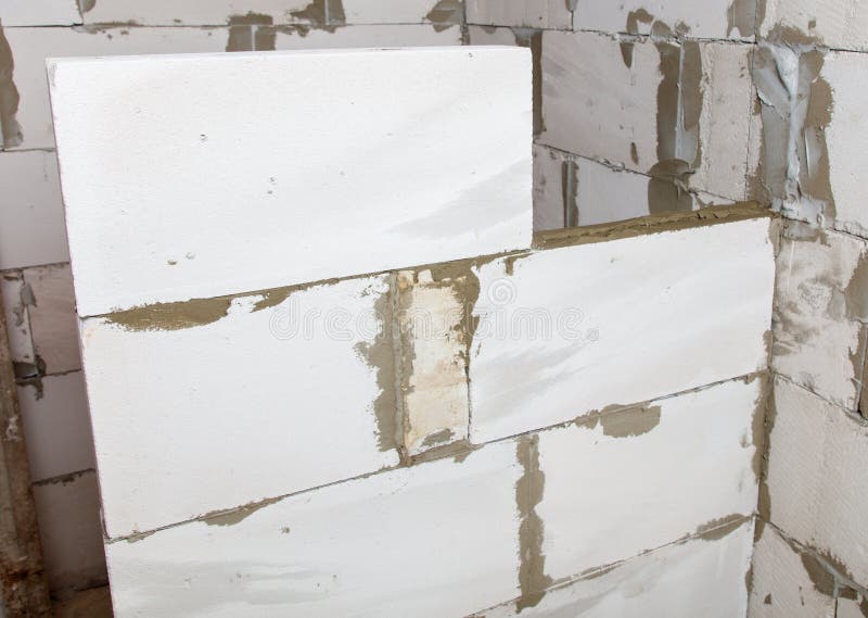 A Wall Made of White Bricks with a White Cement Base Stock Photo ...