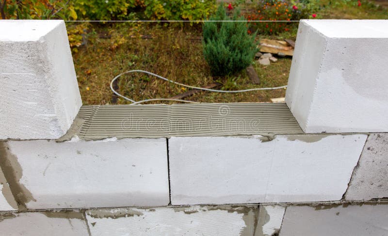 A Wall Made of White Bricks with a Wire Running through it Stock Photo ...
