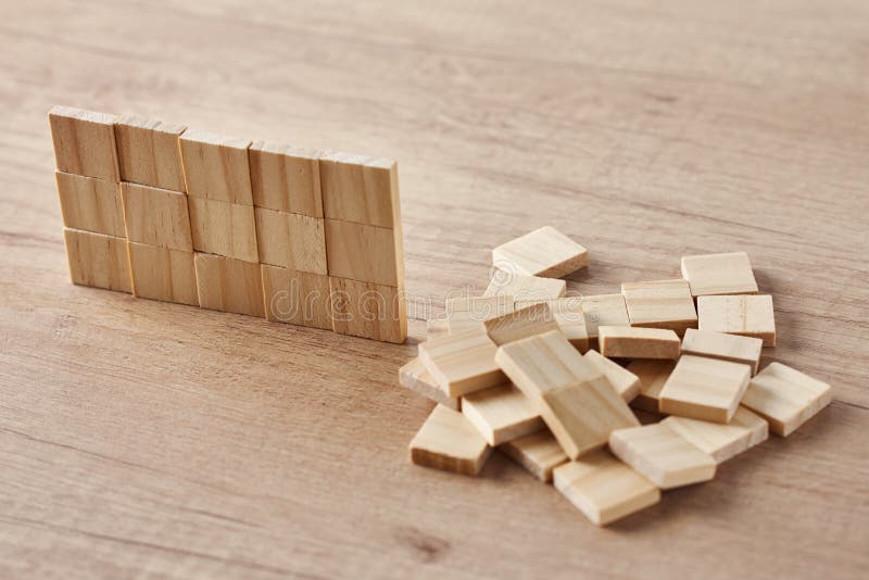 Wall Made of Wooden Blocks on the Wood Table. Finishing Task Concept ...