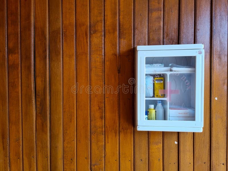 A Wall-mounted First Aid Box with Medical Supplies Inside, Sits Against ...