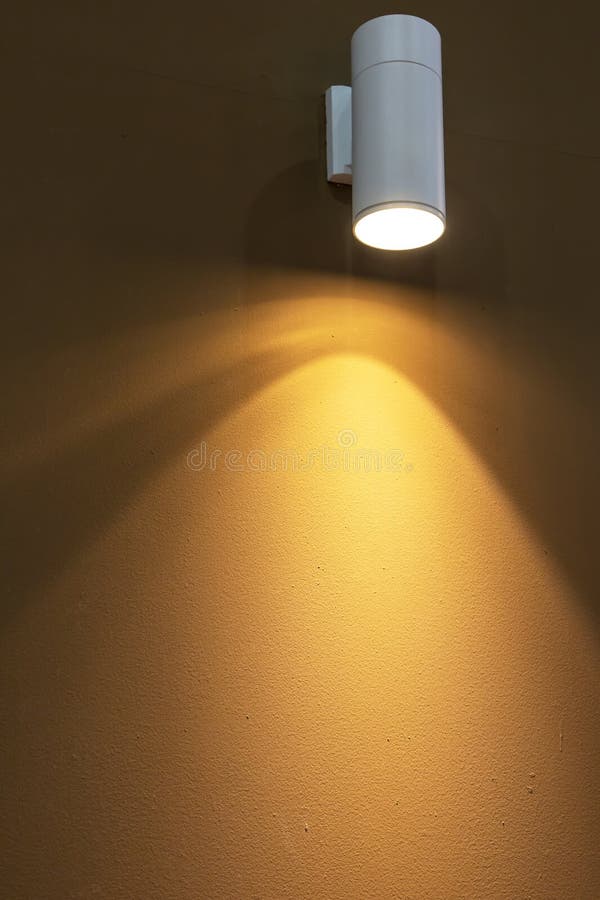 A Wall-mounted Light Bulb Illuminates the Walls of the Room Stock Photo ...