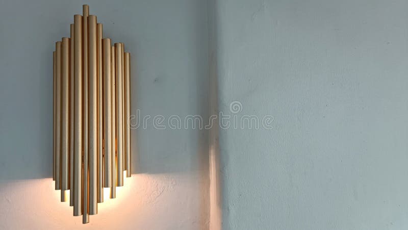 A Wall Mounted Light Fixture with Gold Colored Rods Stock Image - Image ...
