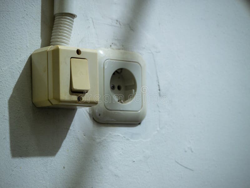 A Wall-mounted Light Switch and an Electrical Power Outlet Side by Side ...