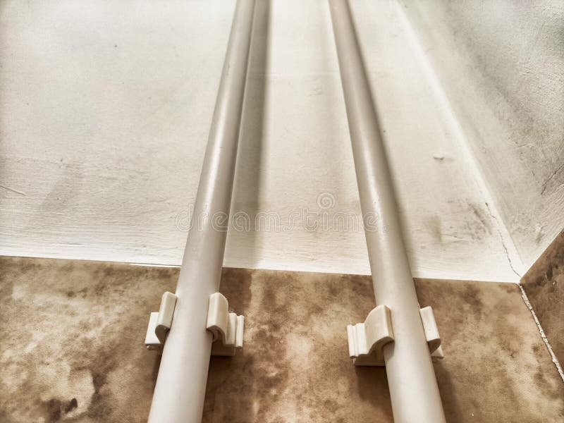 Wall-mounted Poles Installed in a Plain Interior, Showcasing ...