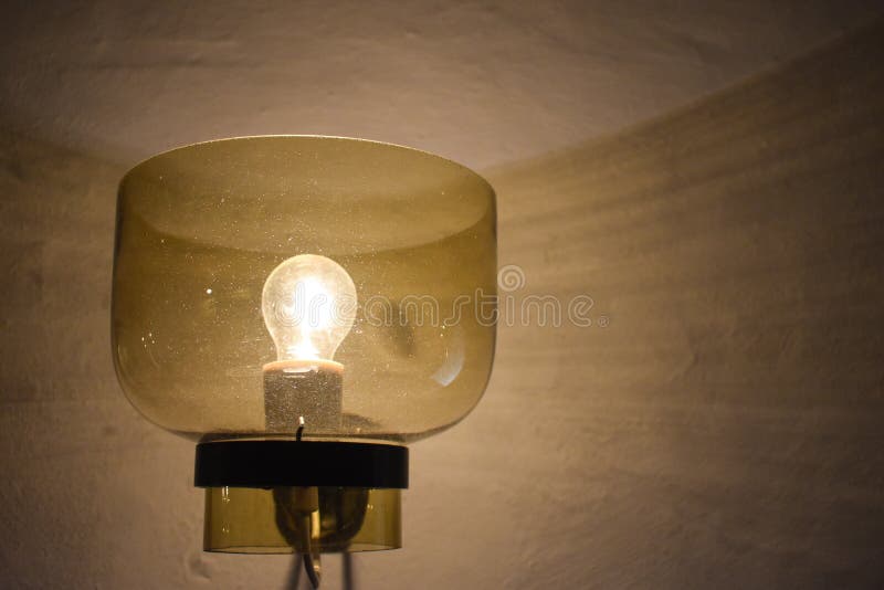 Wall mounted yellow lamp stock image. Image of view - 123453165