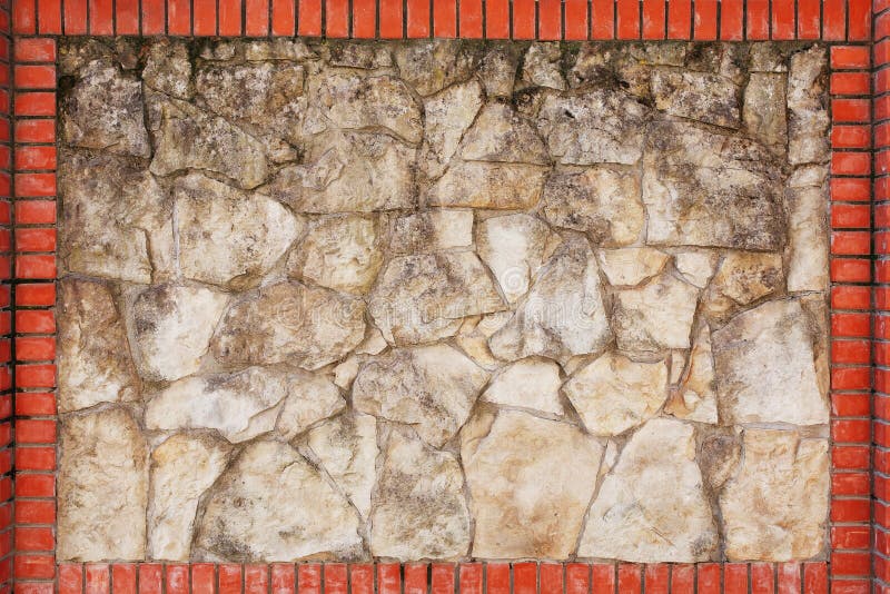 Wall of Natural Light Stone in a Red Brick Frame. Stock Image - Image ...