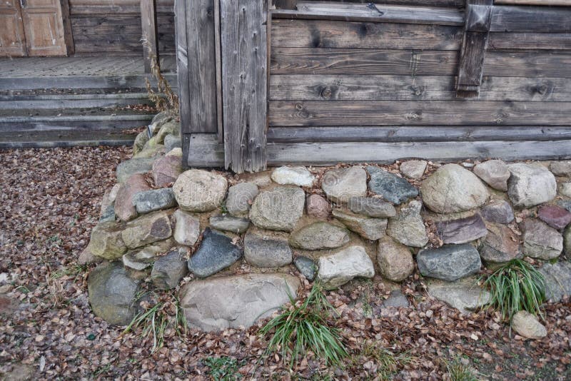 The Wall of an Old Wooden House on a Stone Foundation Stock Photo ...