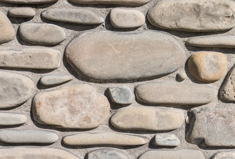 Wall with Oval Stones and Mortar Stock Photo - Image of closeup ...