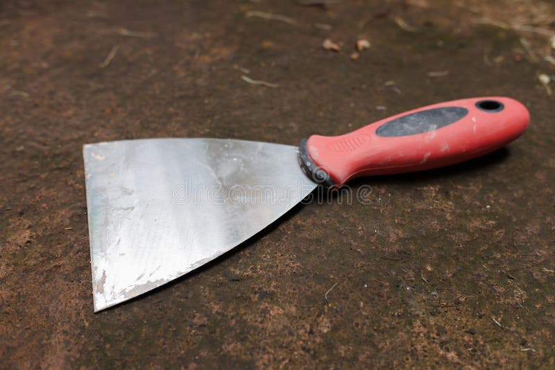 A Wall Paint Scraper with a Red and Black Handle Stock Image - Image of ...