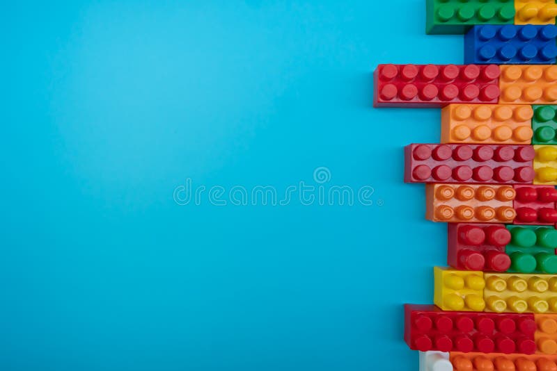Wall from Plastic Building Blocks Isolated on Blue Background. Left ...