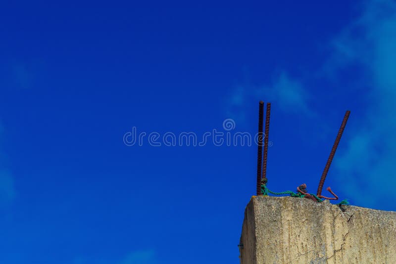 A Wall with Protruding Iron Fittings Against the Background of a Clear ...
