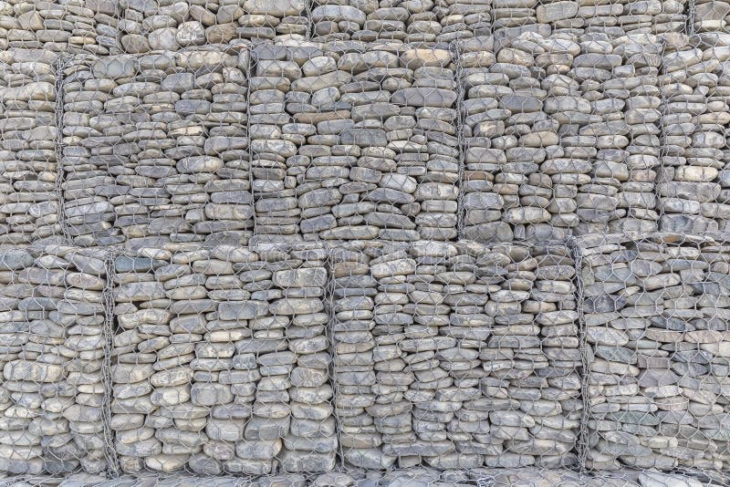 The Wall of River Stones Packed in a Metal Grid Stock Image - Image of ...