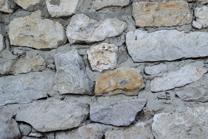 Rough Hewn Stone Forming a Wall Stock Image - Image of piled, texture ...