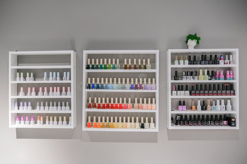 A Wall of Shelves with Many Bottles of Nail Polish Stock Photo - Image ...