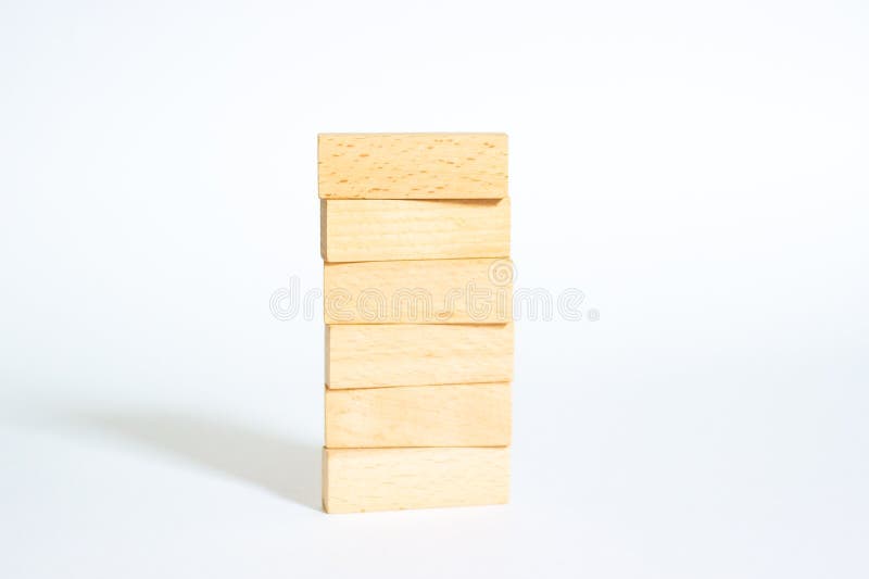 A Wall of Six Wooden Blocks is Built Vertically Up on a White ...