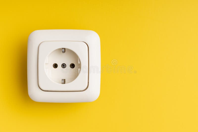 Wall socket on yellow wall stock image. Image of energy - 254827251