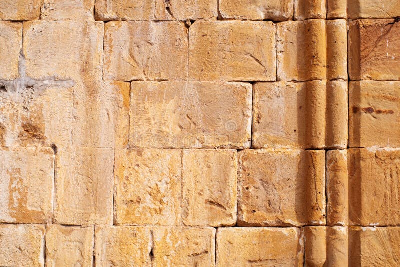 A Wall of Stone Blocks with Carved Columns of an Ancient Temple in the ...