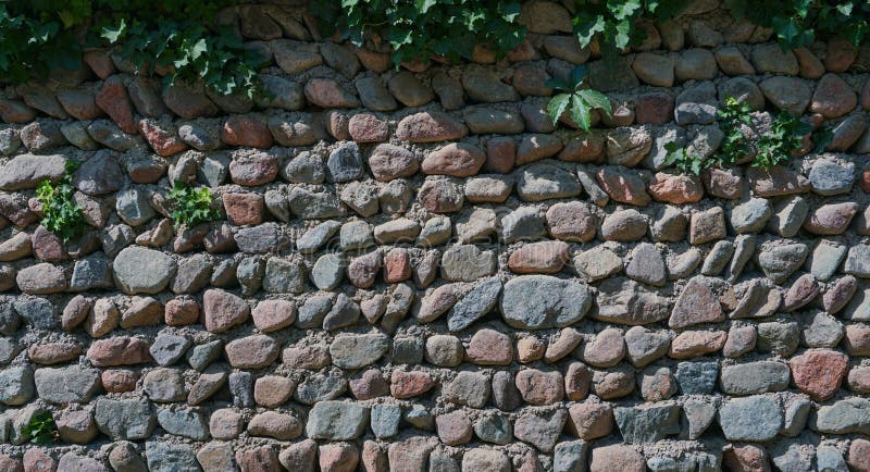 A Wall Structure Made of Round Stones Stock Image - Image of brown ...