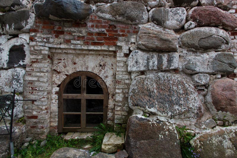 A Wall with a Window Made of Large Cobblestones and Bricks in One of ...