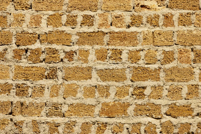 A Wall of Yellow Blocks, Textured Shell Bricks. Background Stock Photo ...