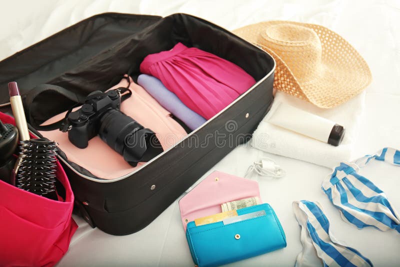 Wallet and Open Suitcase with Packed Things on Bed Stock Image - Image ...