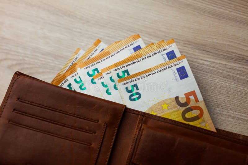 Wallet Stuffed with Euro Banknotes on the Wooden Backround Stock Photo ...