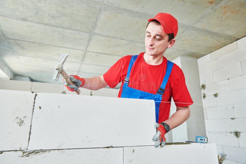 Walling. Bricklayer Installing Autoclaved Aerated Concrete Blocks ...