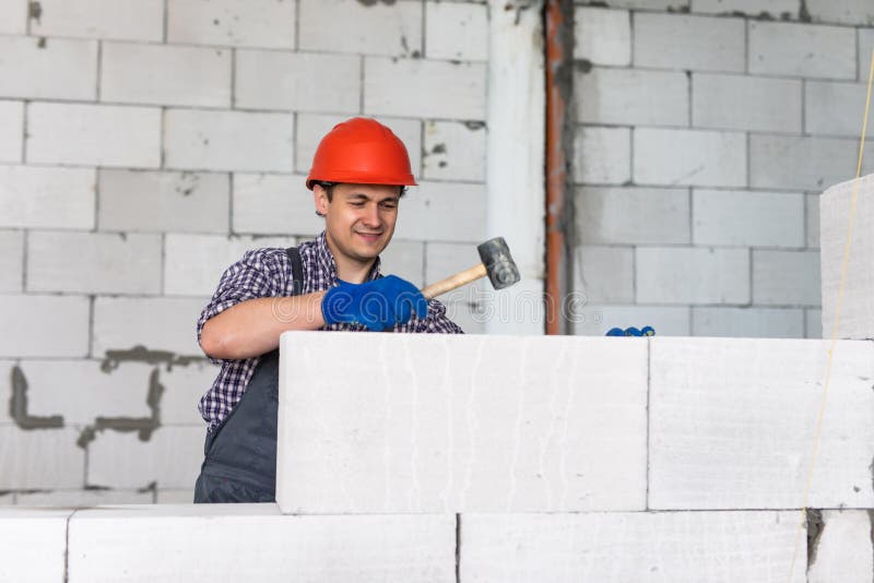 Walling. Bricklayer Installing Wall from Autoclaved Aerated Concrete ...