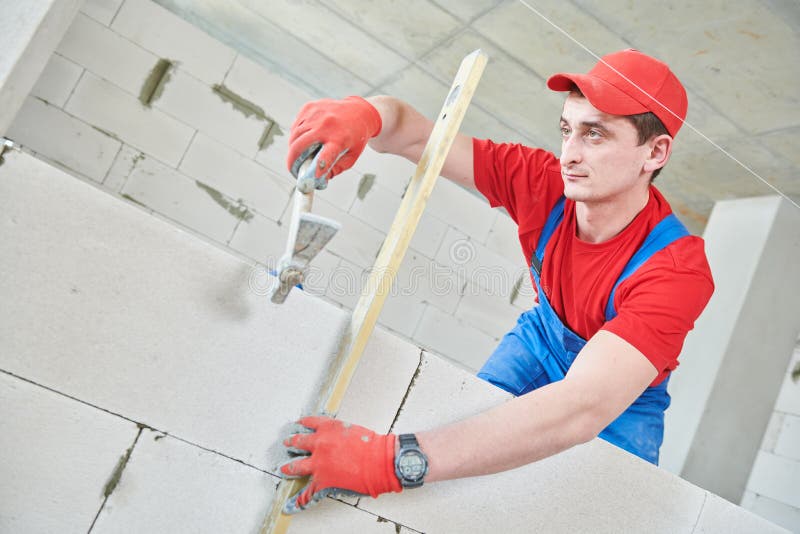 Walling. Bricklayer Installing Wall from Autoclaved Aerated Concrete ...