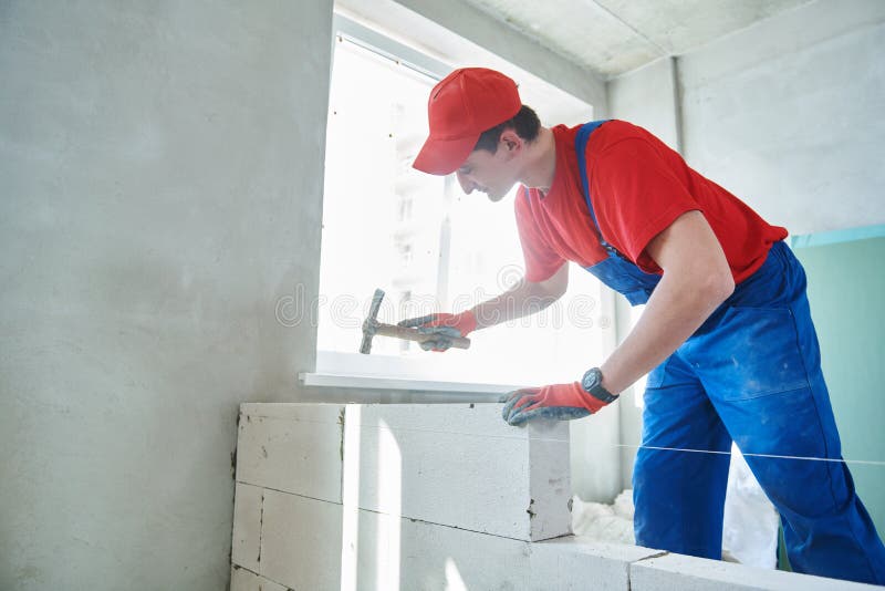 Walling. Bricklayer Installing Wall from Autoclaved Aerated Concrete ...